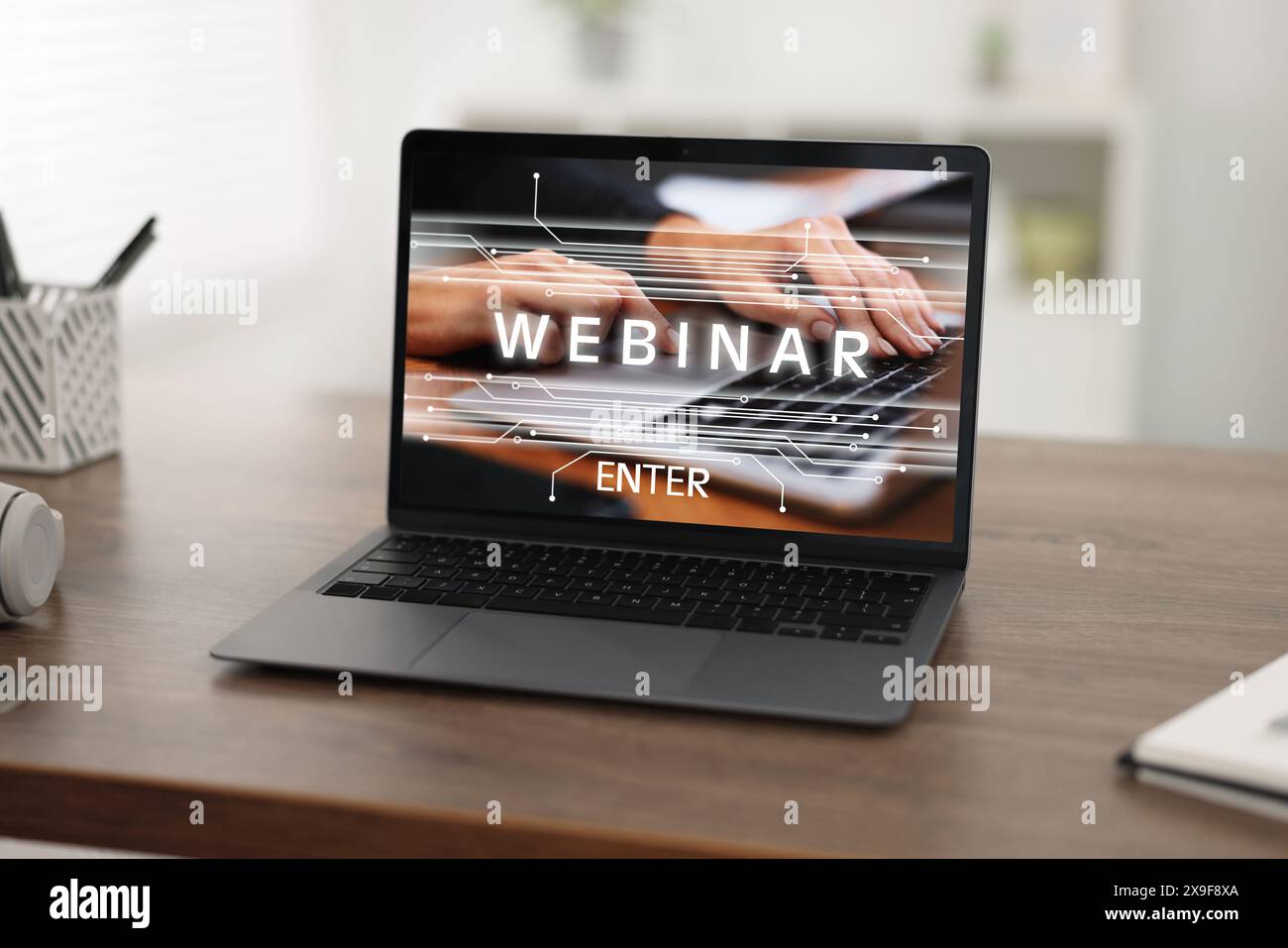 Webinar page open on laptop screen at workplace Stock Photo - Alamy