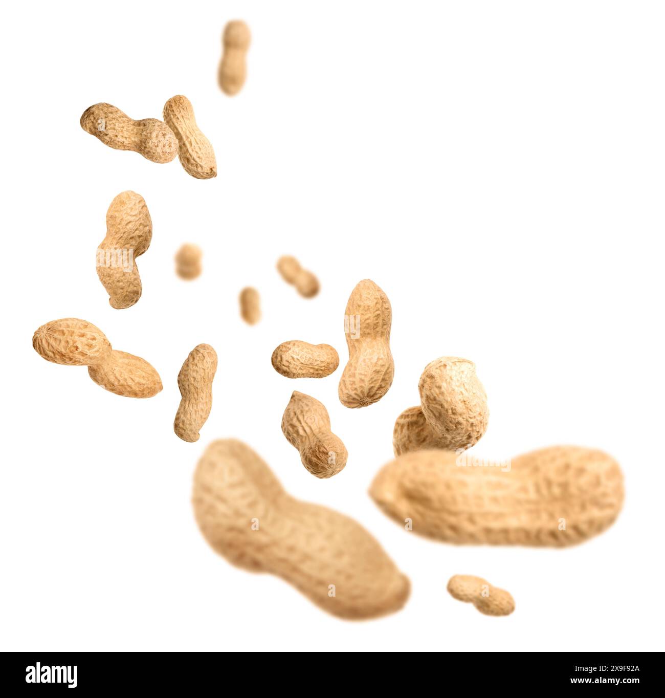 Unpeeled peanuts in air on white background Stock Photo - Alamy