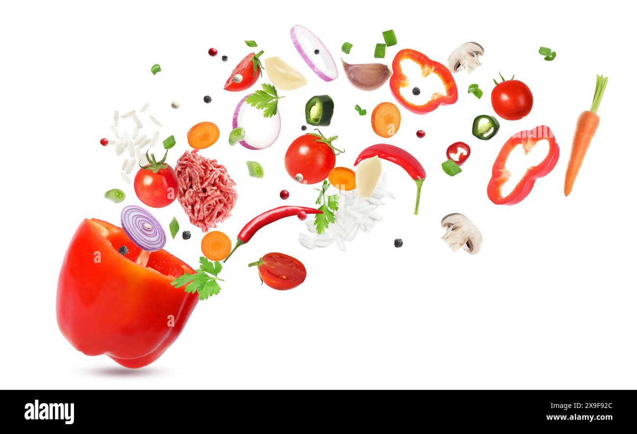 Stuffed pepper recipe. Fresh ingredients falling into bell pepper on ...