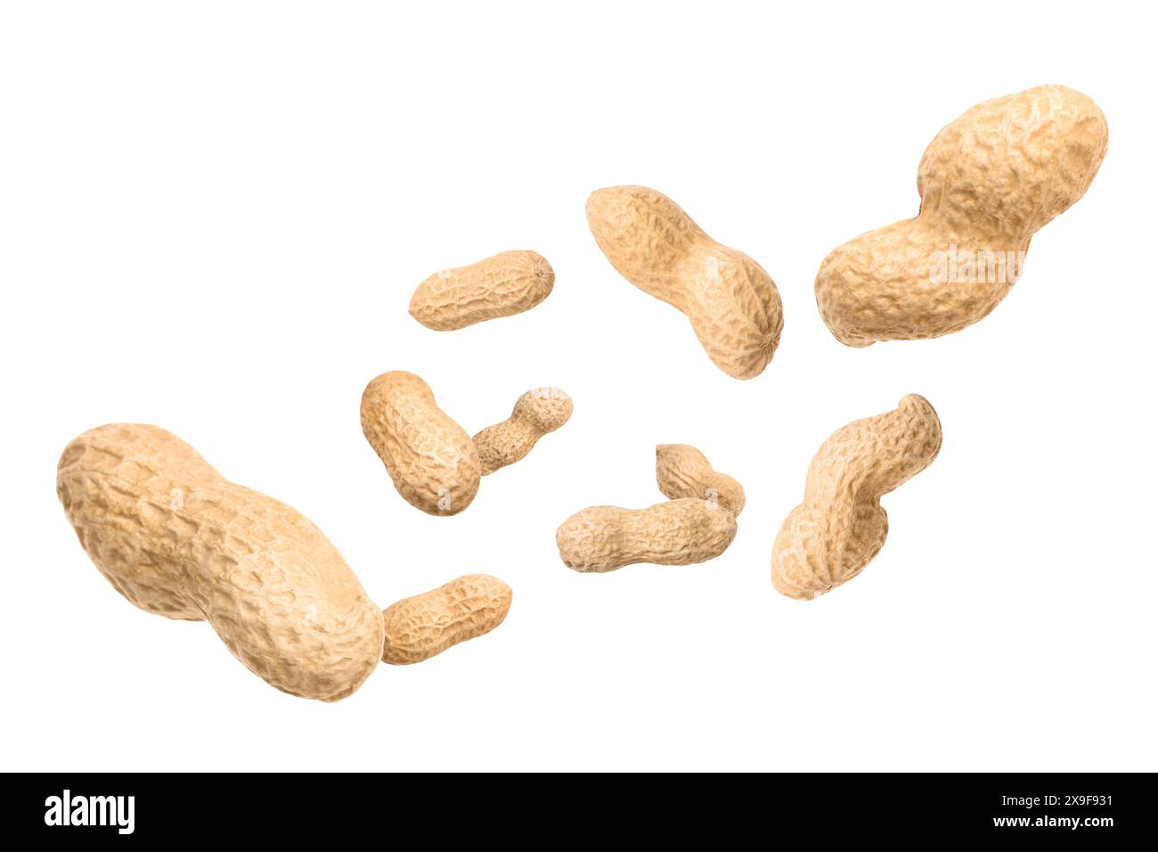 Unpeeled peanuts in air on white background Stock Photo - Alamy