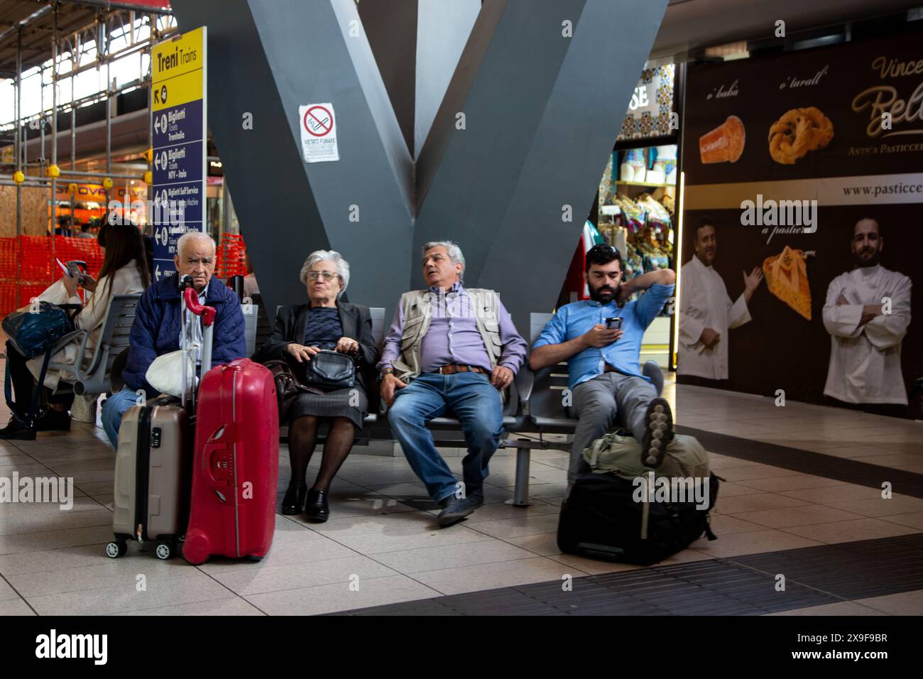 travelers waiting inside Naples Central Station, crowded commuters ...