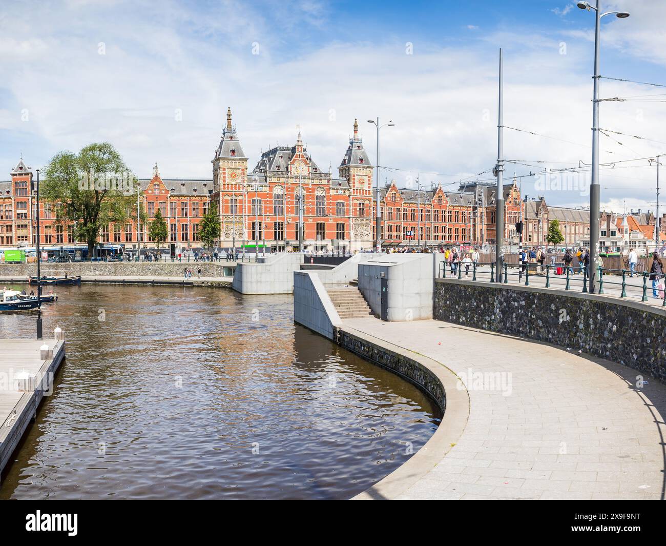 The waterway and embankments in front of the busy Amsterdam Centraal ...