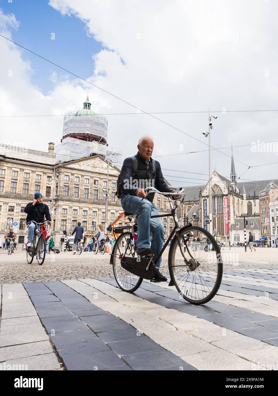 A man pictured riding his bike away from the Royal Palace and across ...