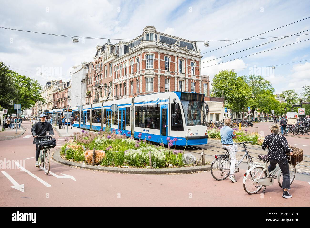 Cyclists and trams navigating the streets of Amsterdam seen in the ...