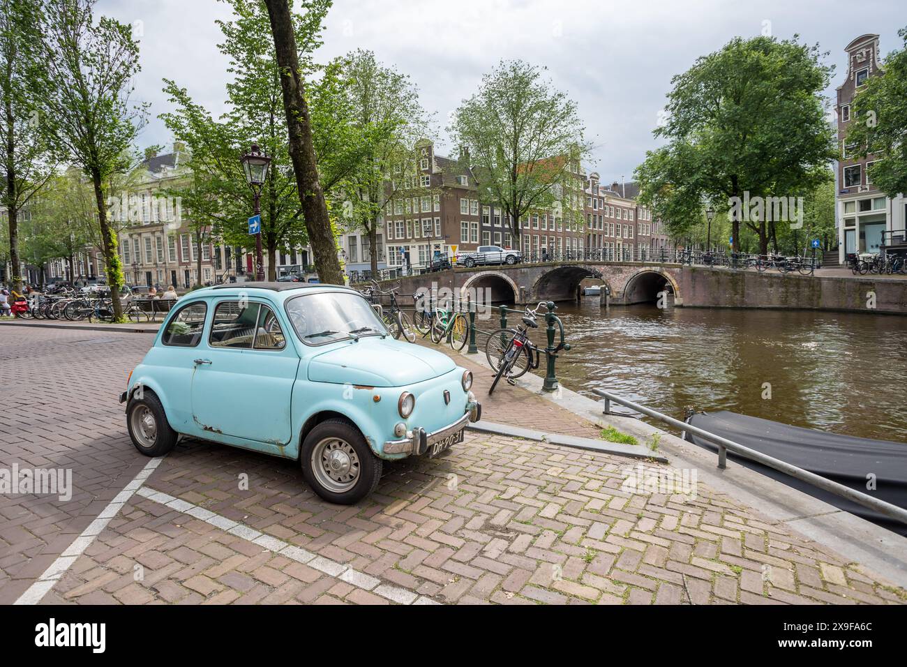 A light blue old fashioned car pictured by the Gentlemens Canal in ...
