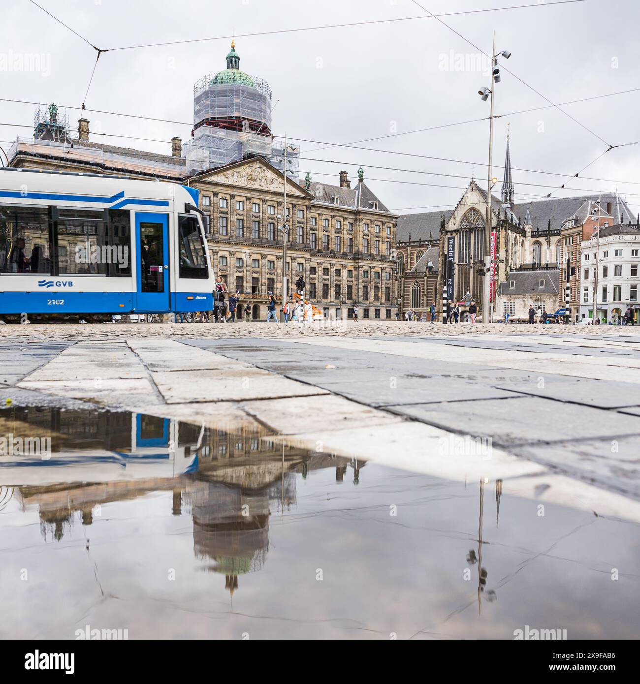 Reflections of a tram passing through Dam Square with the Royal Palace ...