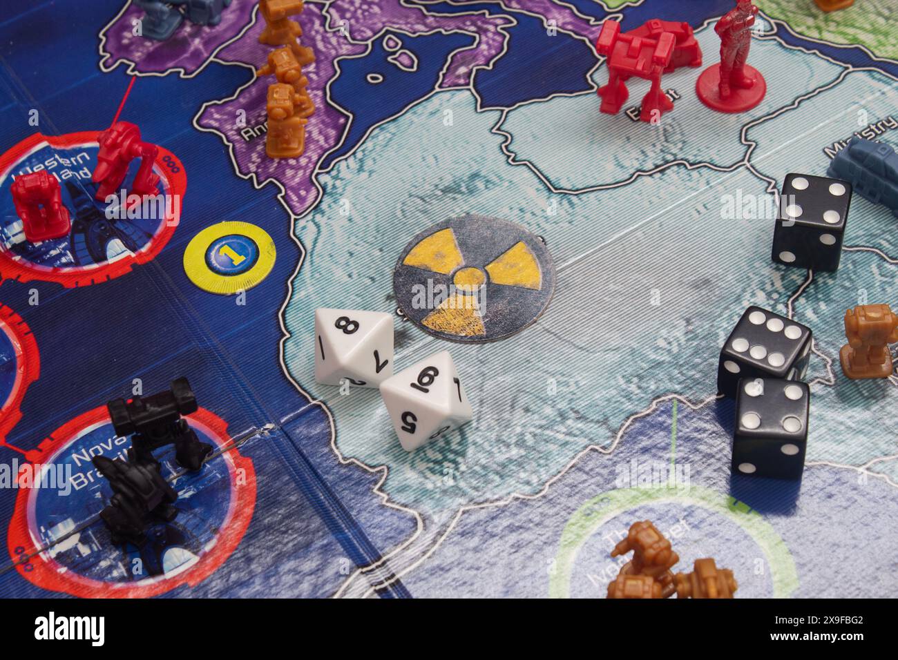 Macro radioactive symbol over risk 2210 a.d. board with dice and pawns ...