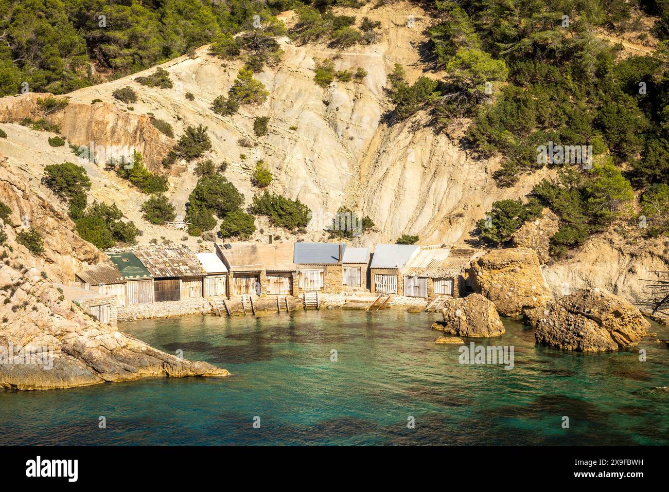 Traditional fishing boat huts in Es Portitxol cove, Sant Joan de ...