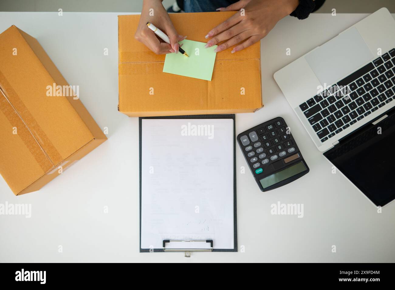 SME entrepreneurs prepare packages and verify customer information ...