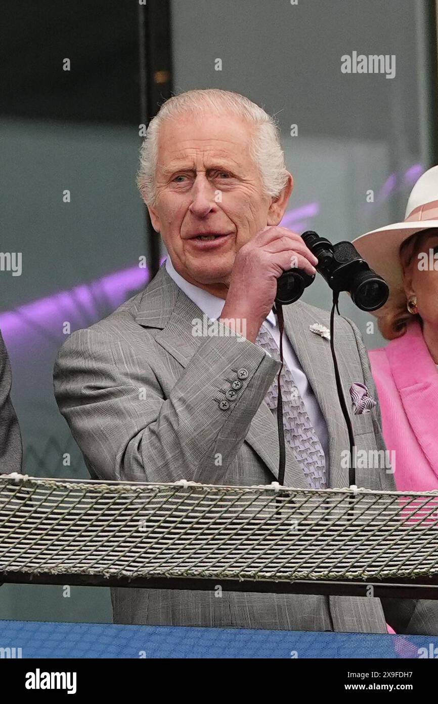 King Charles III watches as horse Treasure races in The Oaks during the ...