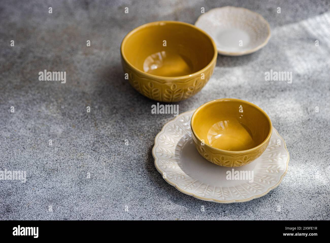 Close-up of four empty ceramic plates and bowls on a table Stock Photo ...
