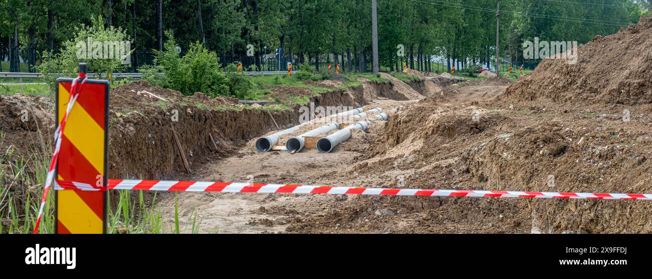 New fiber glass water pipeline in trench. Replacement of old rusty ...