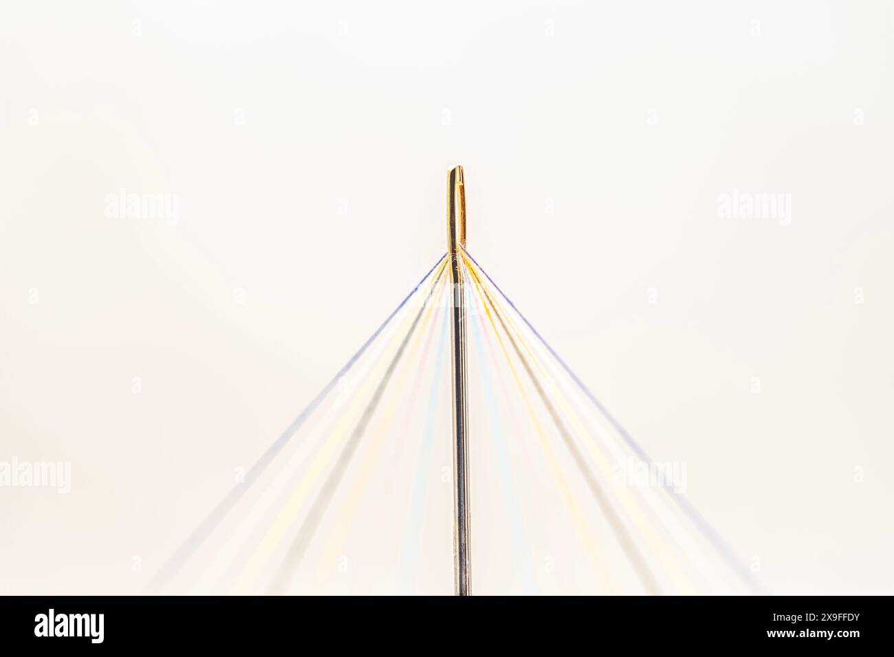Rainbow Colored Threads Through Needle Eyelet Stock Photo - Alamy
