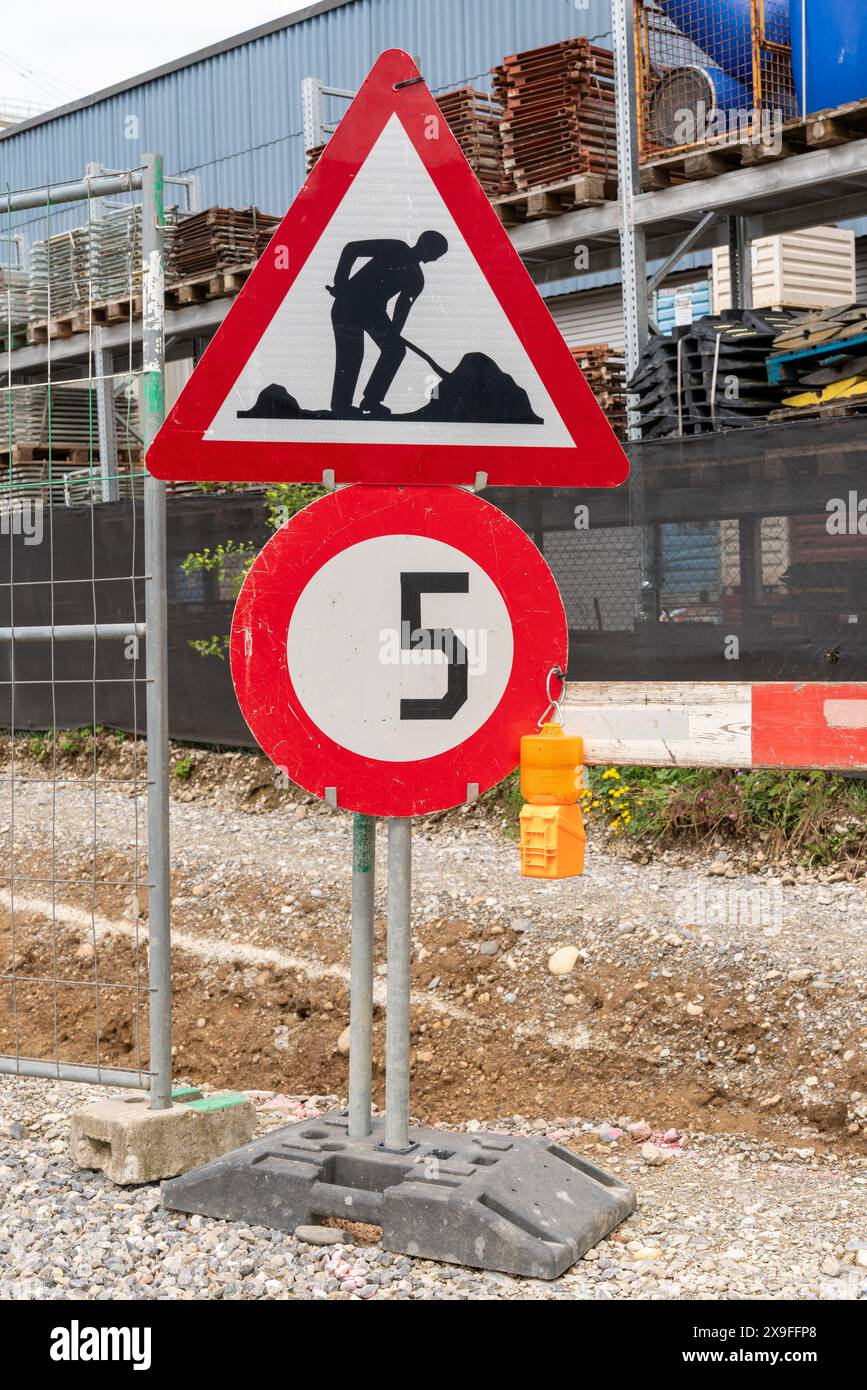 Construction site with gravel road, a speed limit sign with 5km/h and a ...