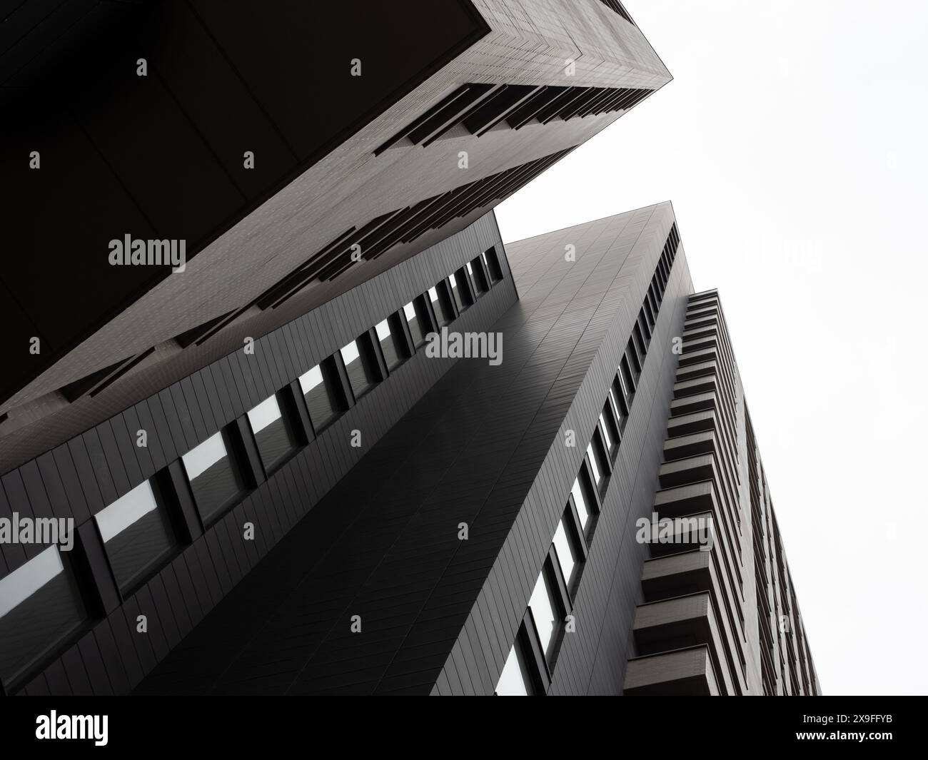 A dramatic low-angle view of modern high-rise buildings under an ...