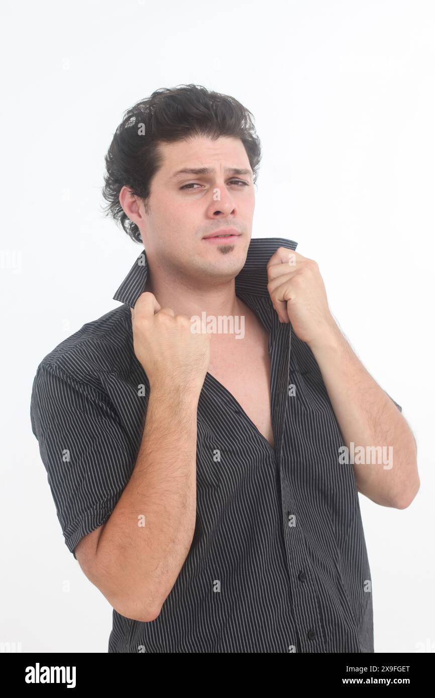 portrait of a handsome young man looking smug Stock Photo - Alamy