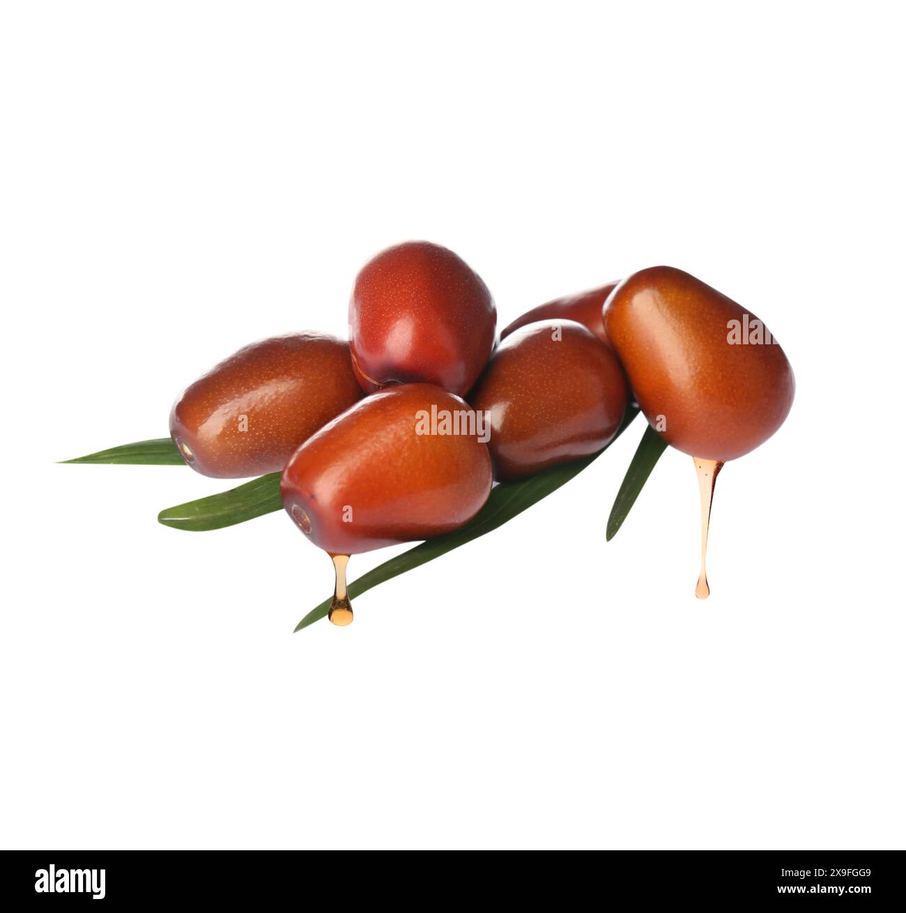 Oil dripping from palm fruits on white background Stock Photo - Alamy