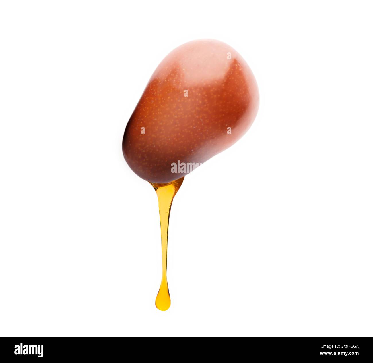 Oil dripping from palm fruit on white background Stock Photo - Alamy
