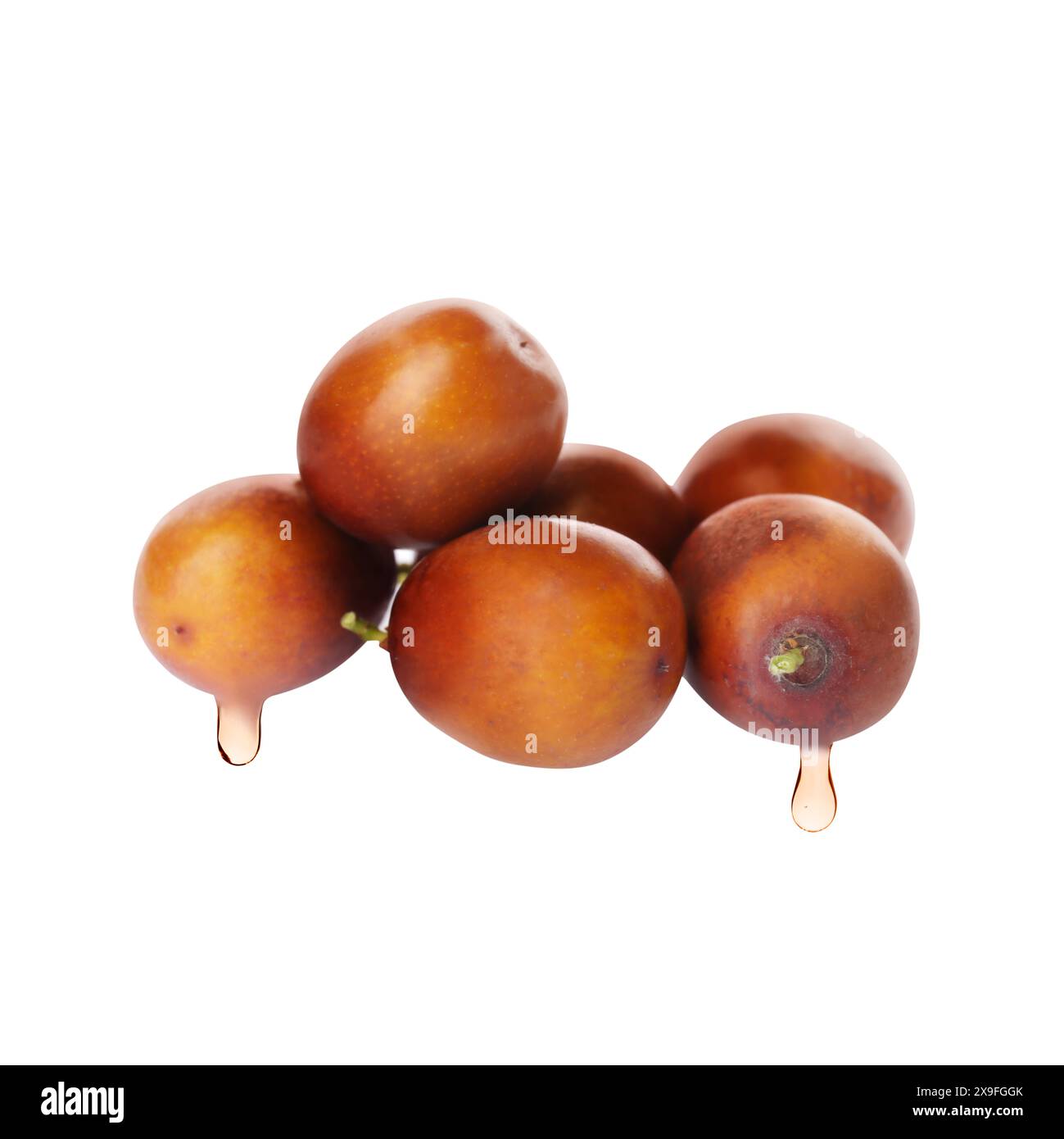 Oil dripping from palm fruits on white background Stock Photo - Alamy