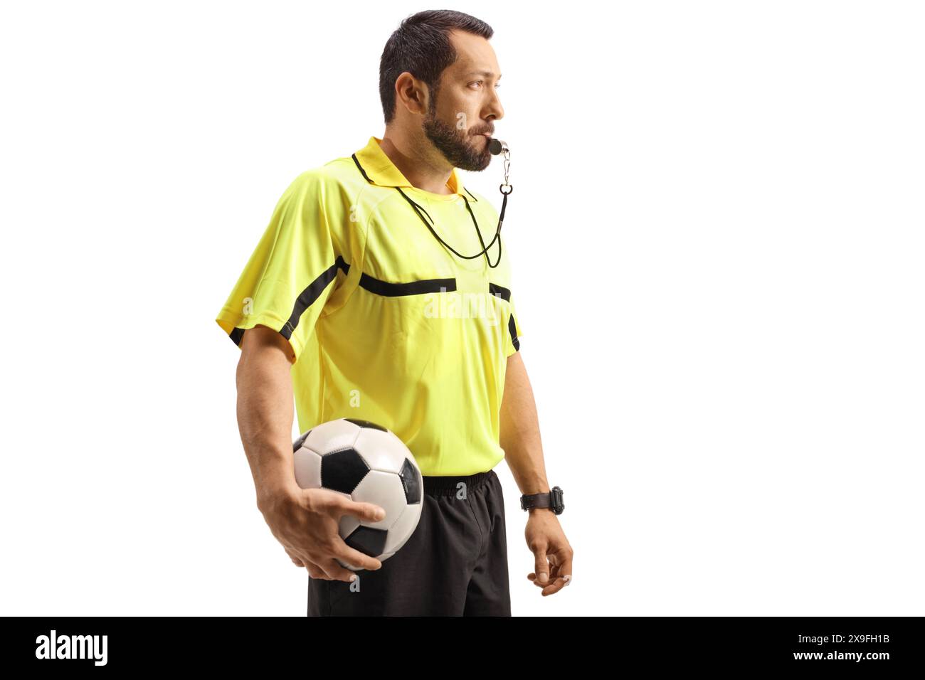 Football referee blowing a whistle and holding a ball isolated on white ...