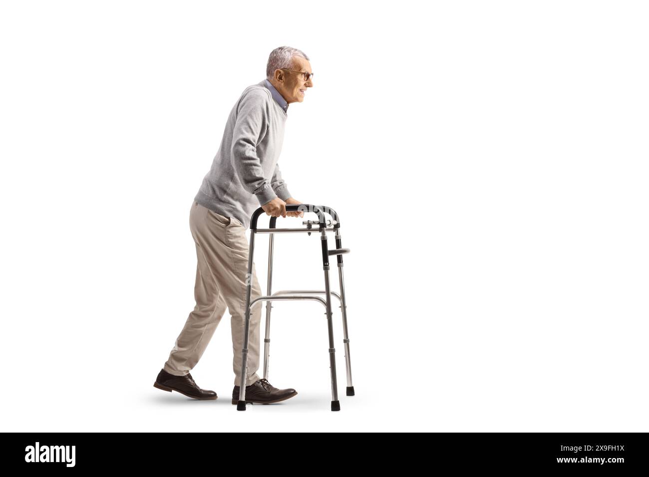 Full length profile shot of an elderly man with a walker isolated on ...