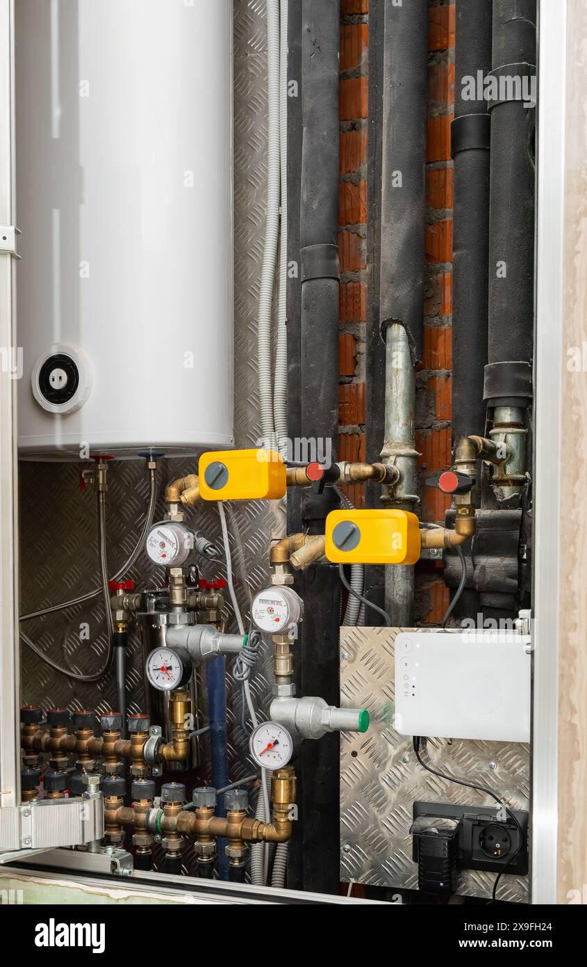 A complex of pipes and measuring devices provides water supply Stock ...