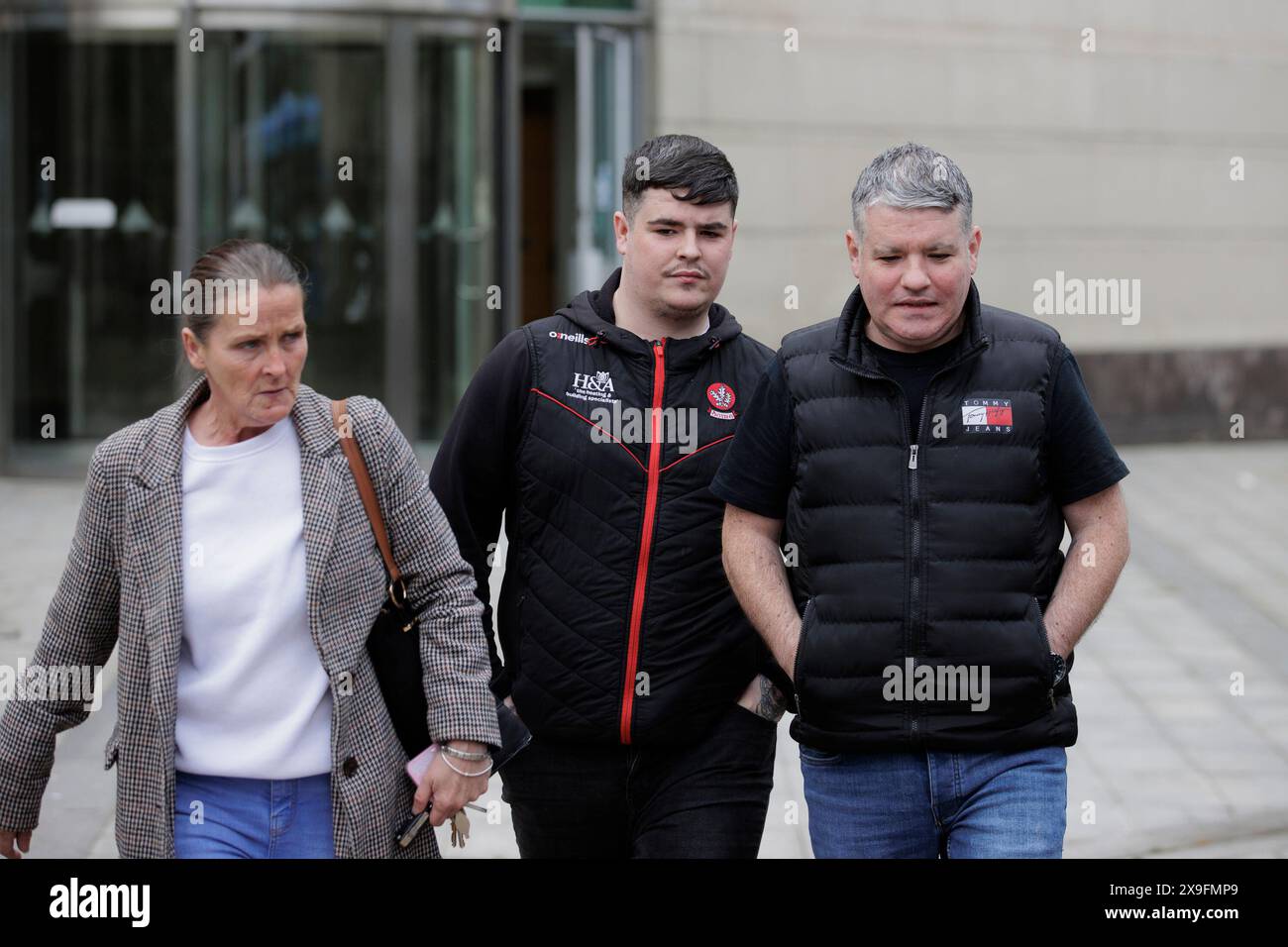 Jordan Devine (centre) leaves Laganside Court, Belfast, where he and ...