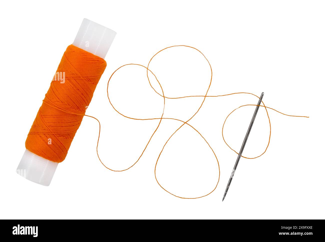 Old spool of thread and needle on a white background. Sewing ...