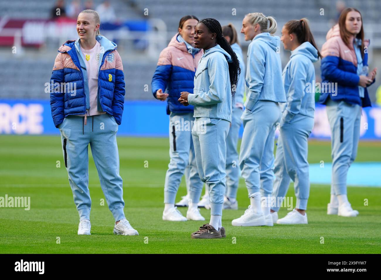 England's Aggie Beever-Jones (left) and Jessica Naz inspect the pitch ...