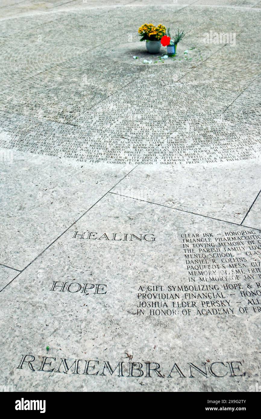 A small pot of flowers is placed at the AIDS Memorial Grove, a ...