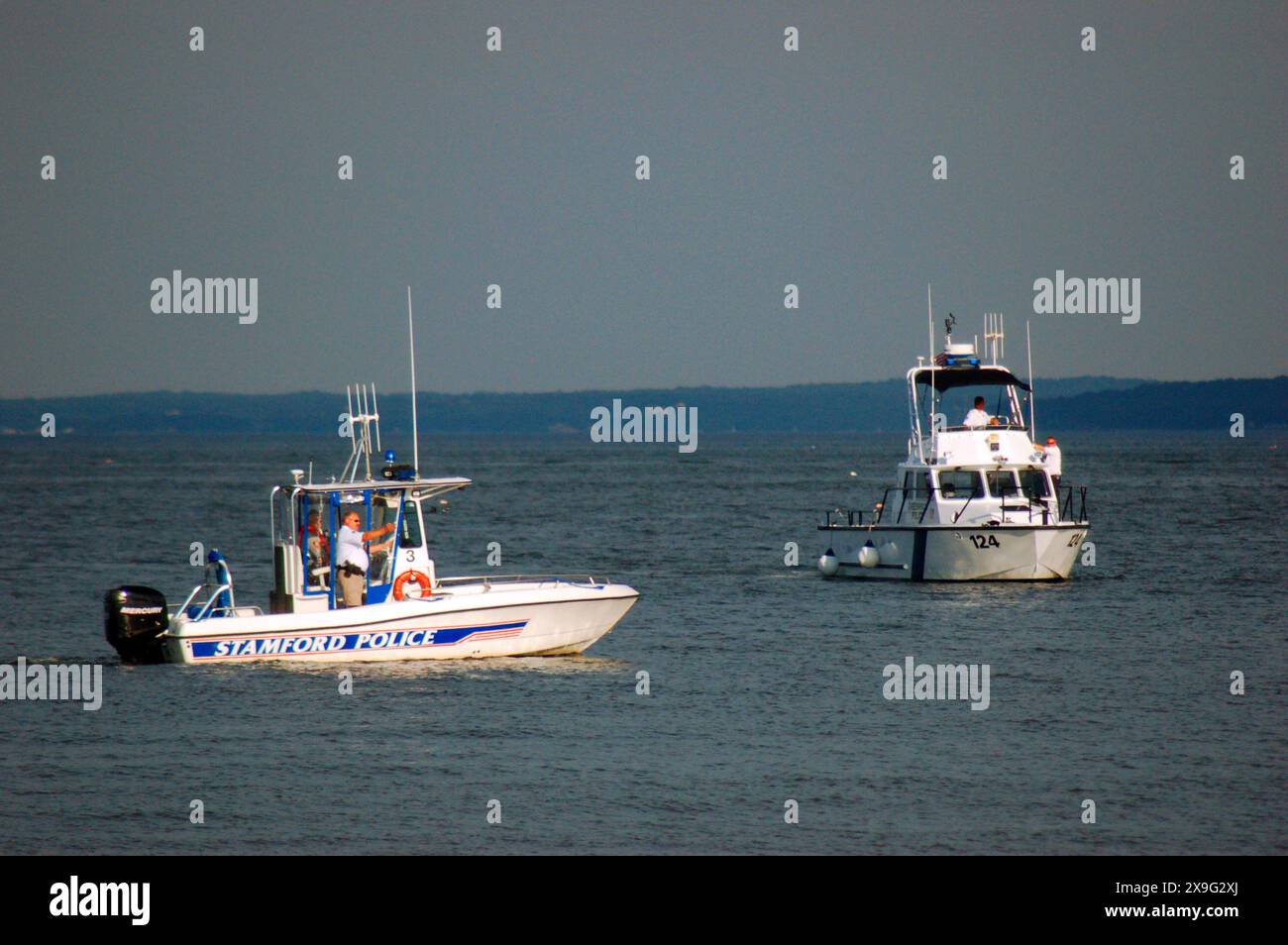 A police boat cruises the waters off the coast of Stamford, Connecticut ...