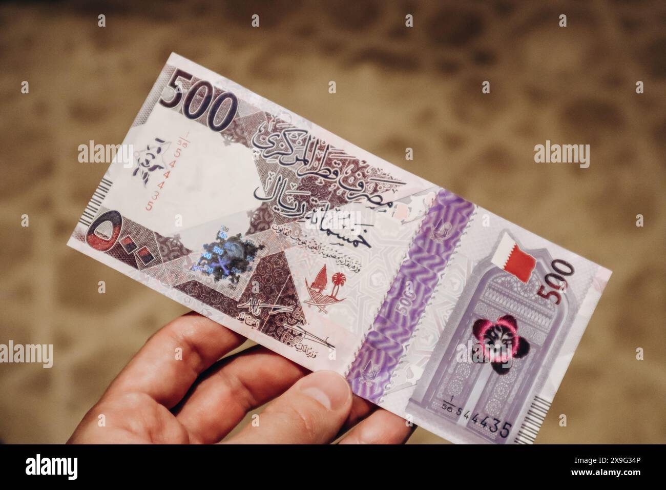 Doha, Qatar - 1 May 2024: Hand holding 500 Qatari rials bill Stock ...