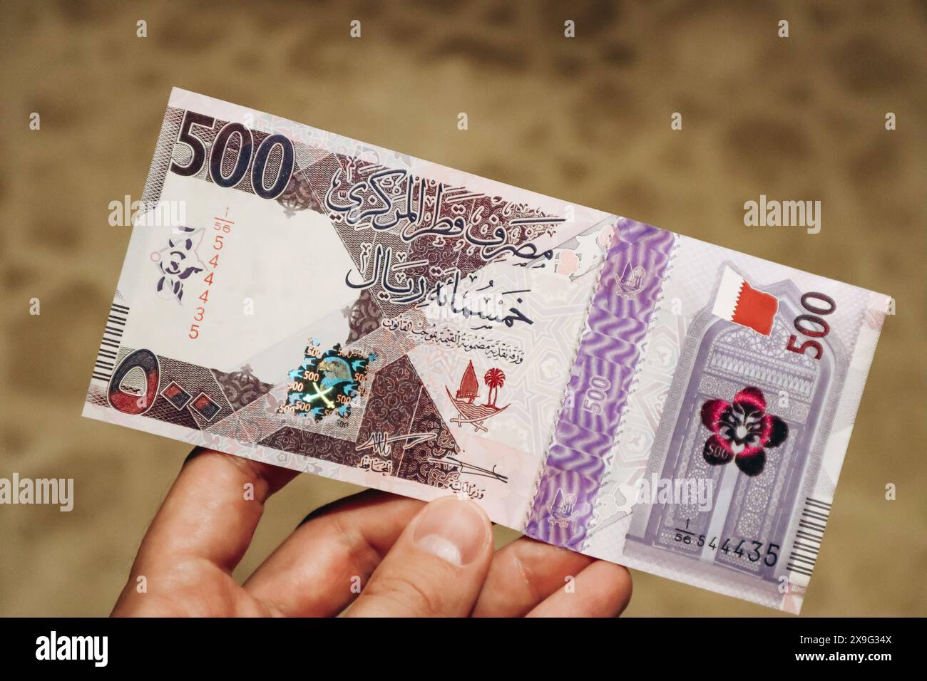 Doha, Qatar - 1 May 2024: Hand holding 500 Qatari rials bill Stock ...