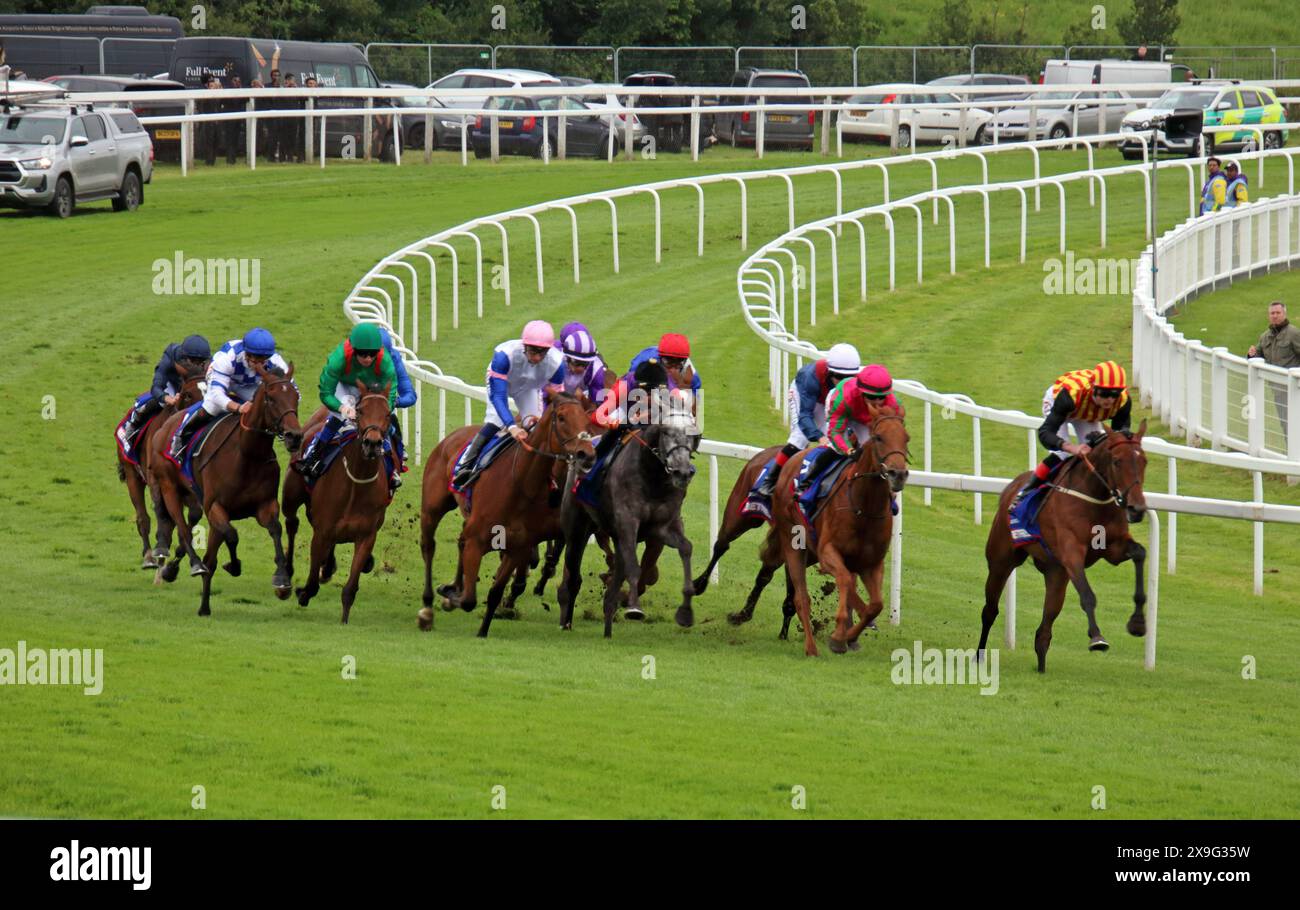 Epsom Downs Surrey, UK. 31st May, 2024. Riders come around Tattenham ...