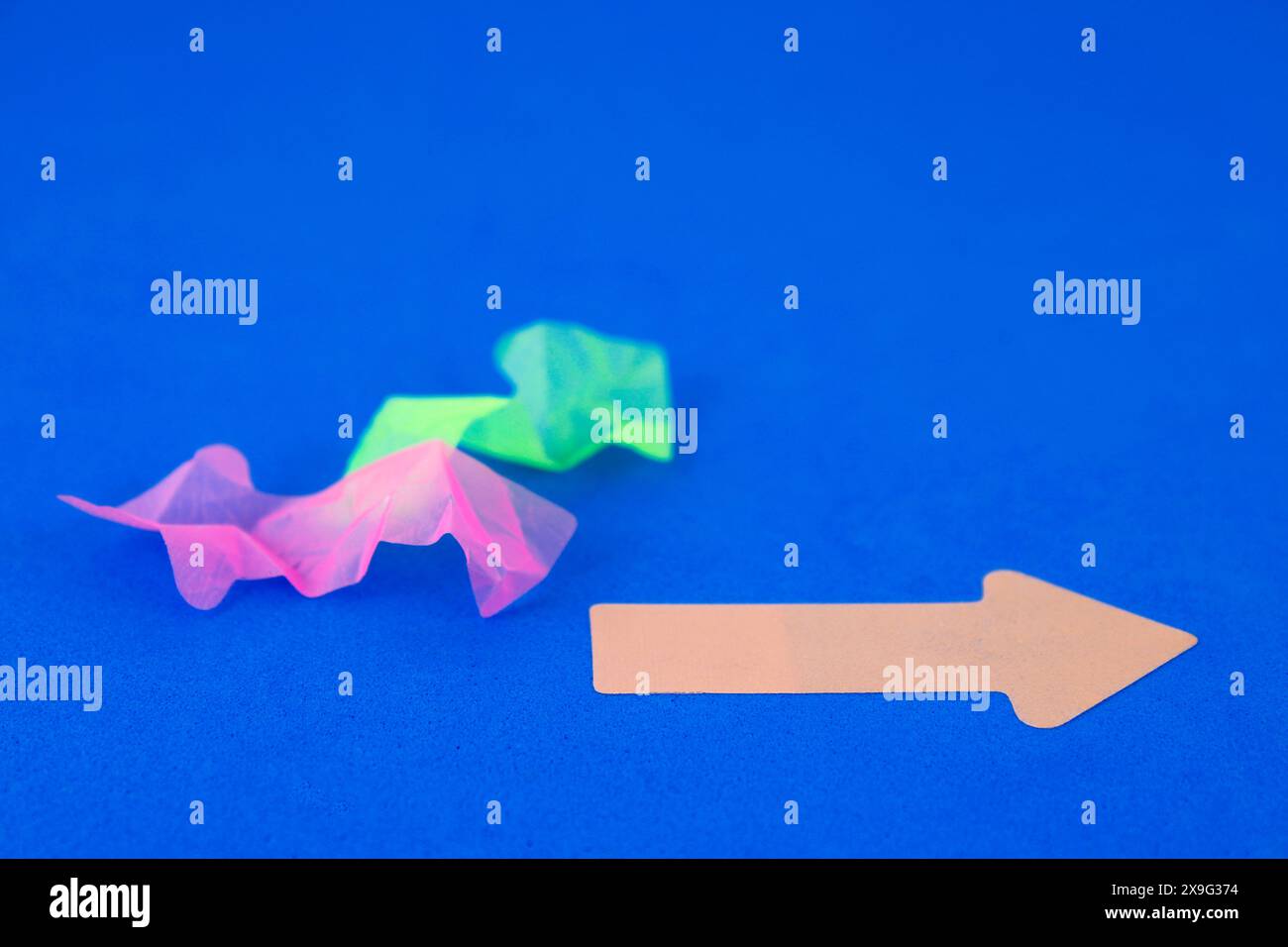 Orange arrow indicating the correct direction to follow Stock Photo - Alamy