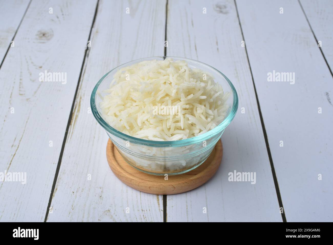 a small serving of basmati rice in a glass bowl on a rustic background ...