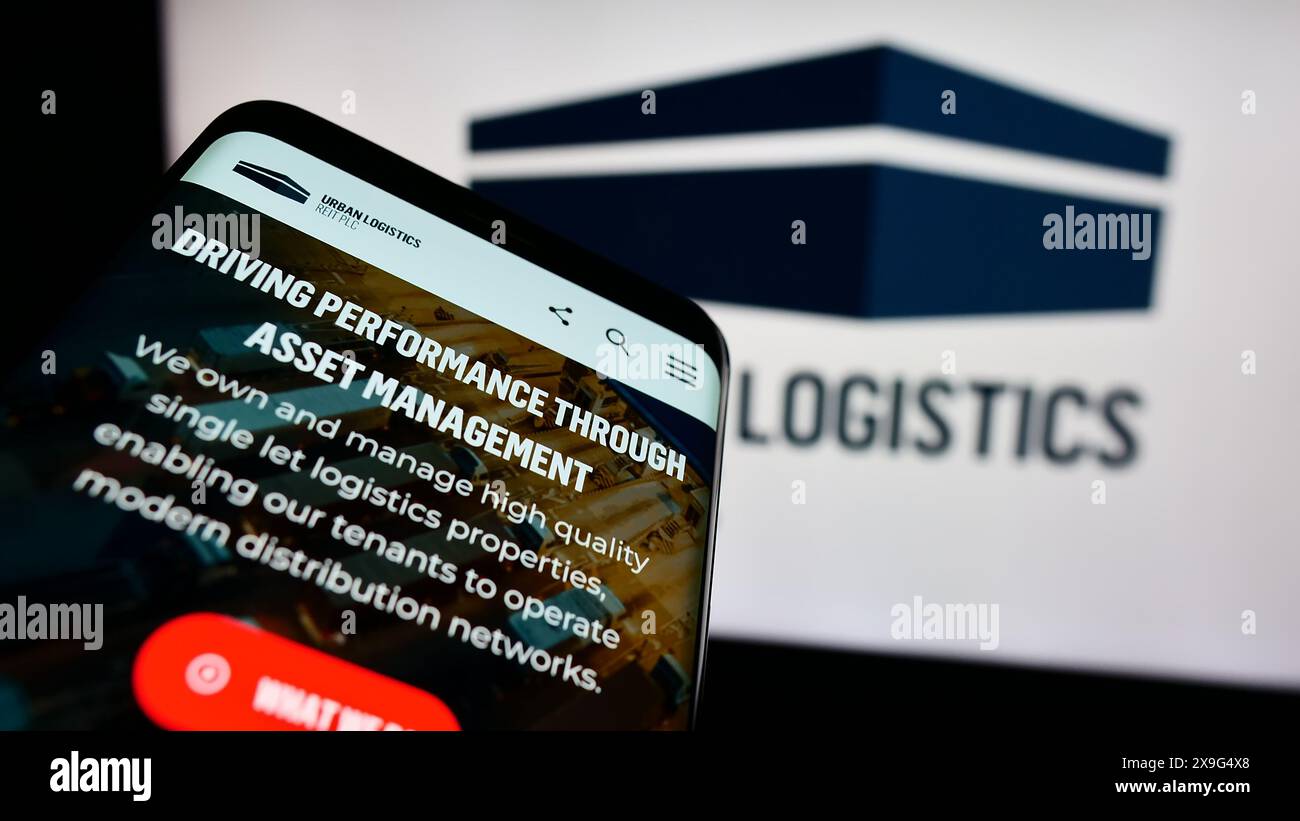 Mobile phone with webpage of British real estate company Urban ...