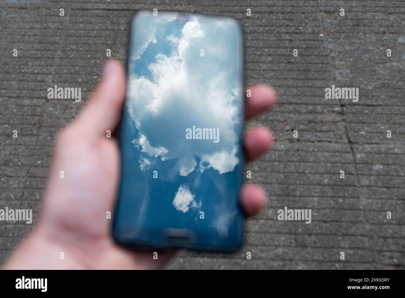 Data cloud reflection on mobile phone screen from the sky. Technology ...