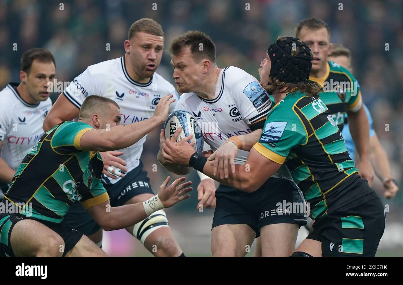 Saracen's Nick Tompkins is tackled by Northampton Saints' Ollie ...