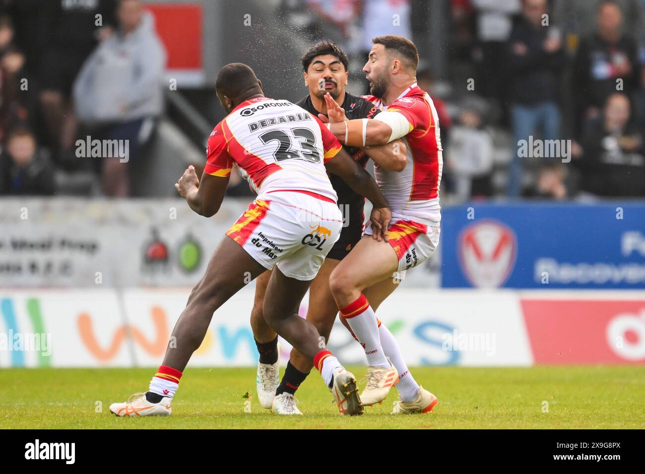 James Bell of St. Helens is tackled by Romain Navarrete of Catalan ...