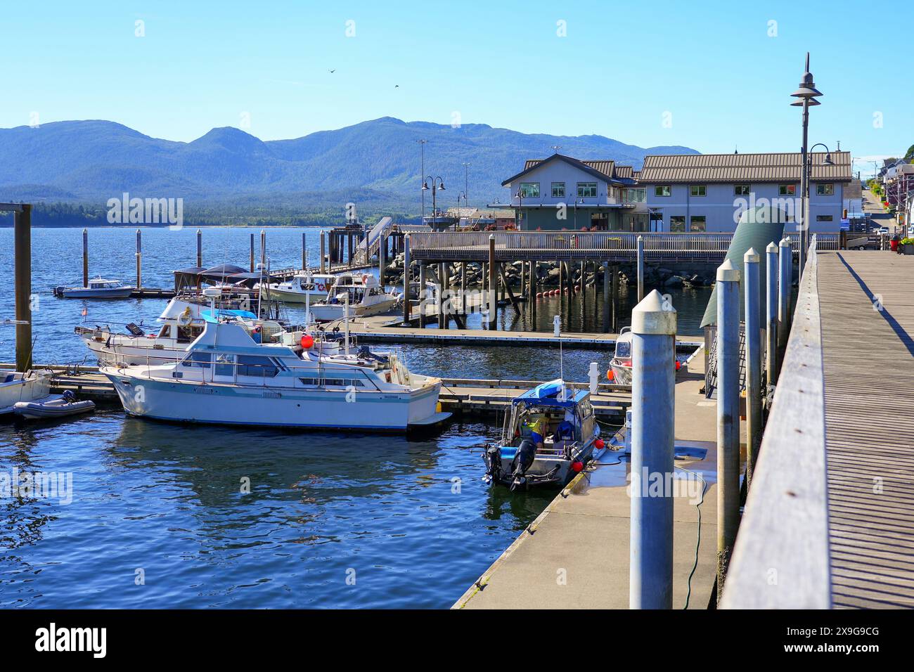 Small boats moored along the elevated walkway of Water Street in ...