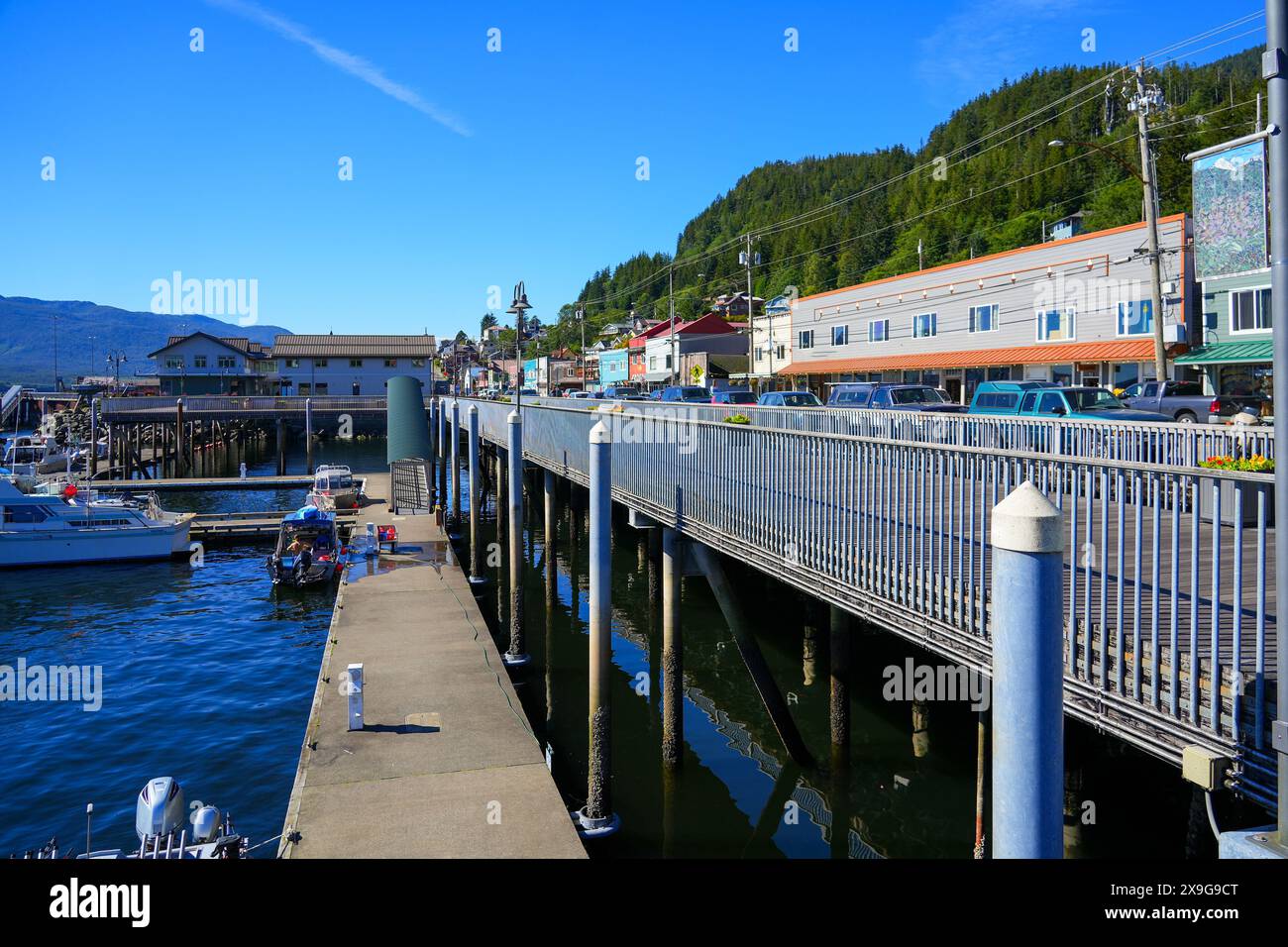 Small boats moored along the elevated walkway of Water Street in ...