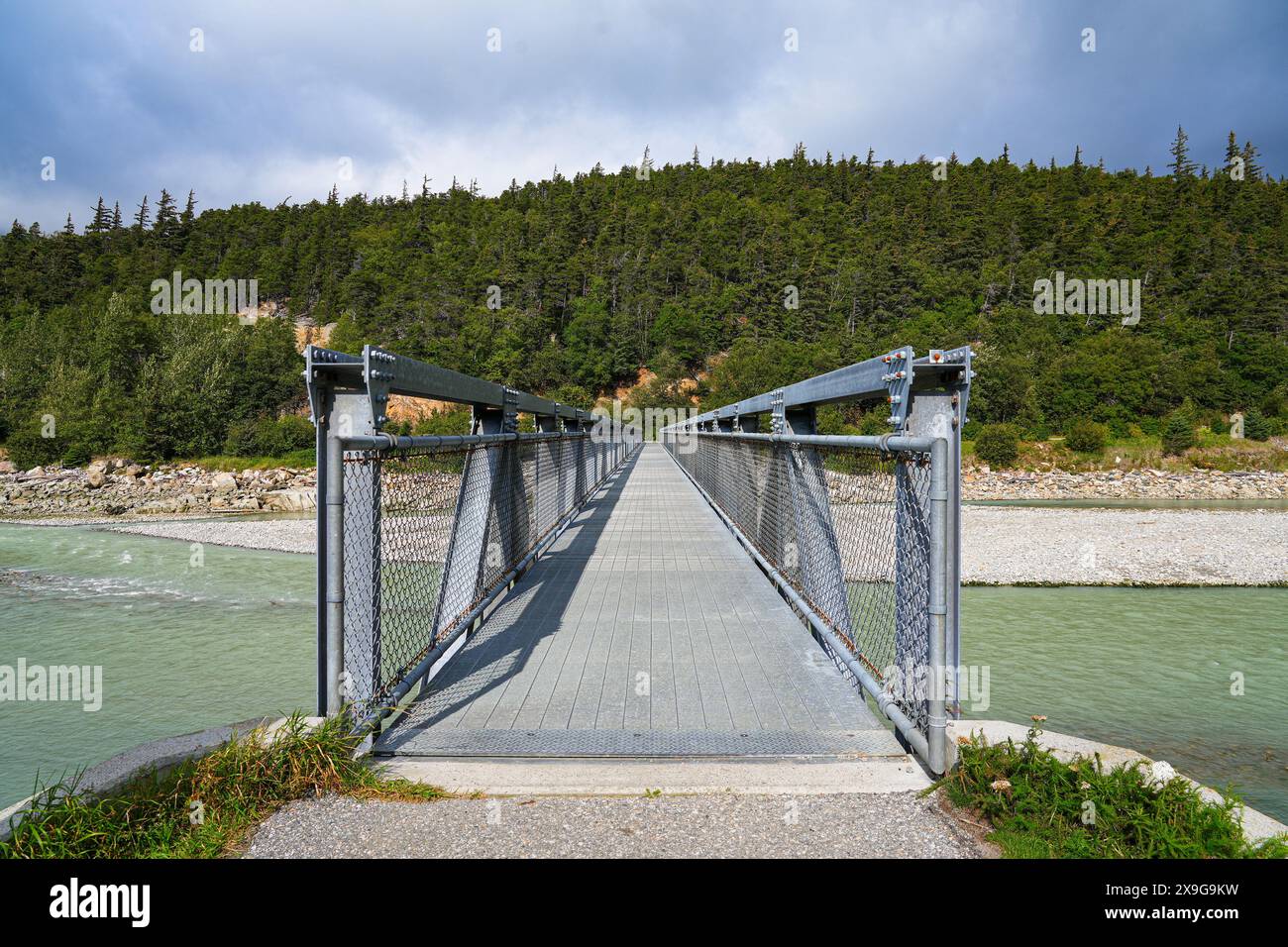 Skagway footbridge spanning the Skagway river of meltwater flowing into ...