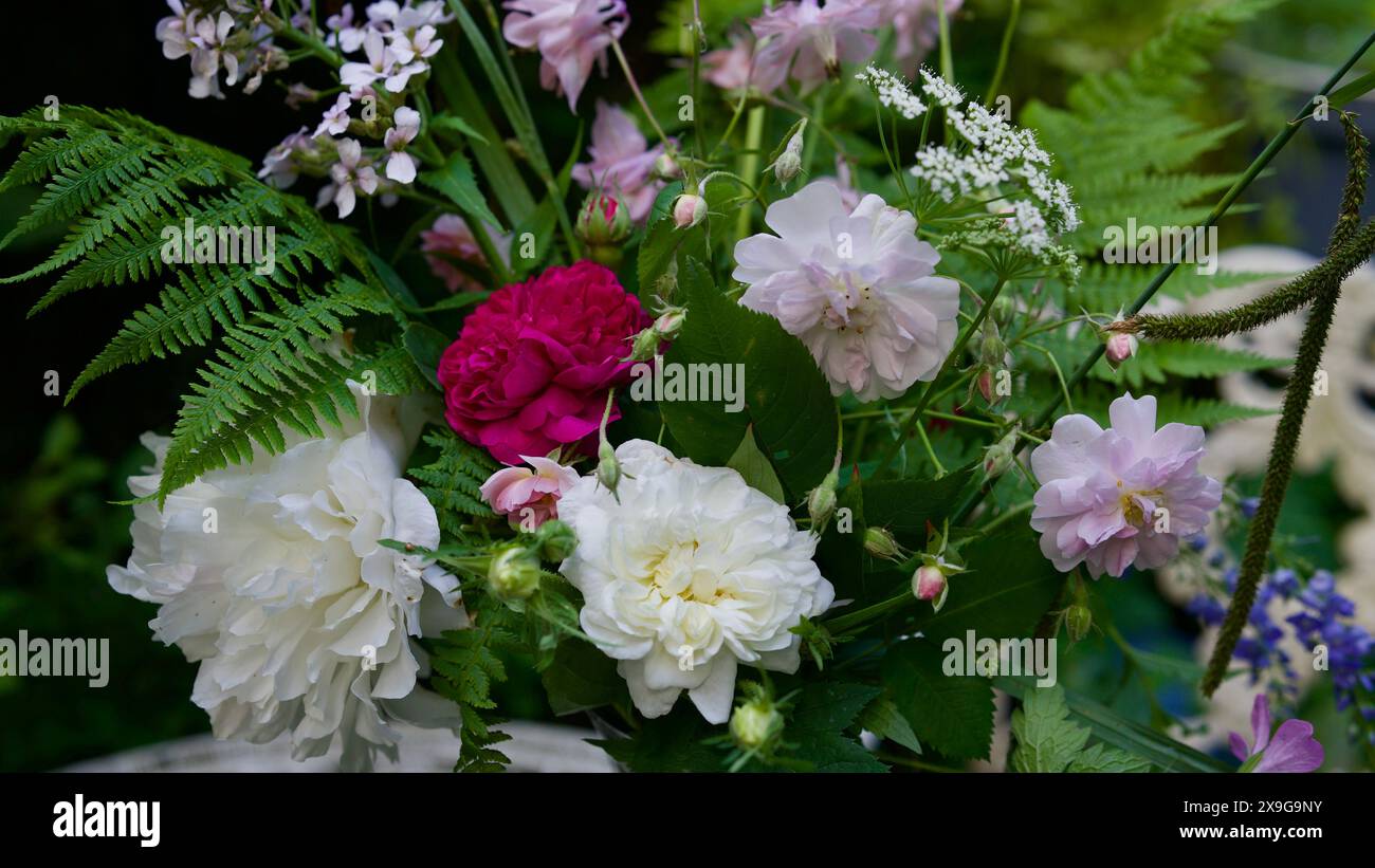 A bouquet of beautiful garden flowers on a white table. Roses Stock ...
