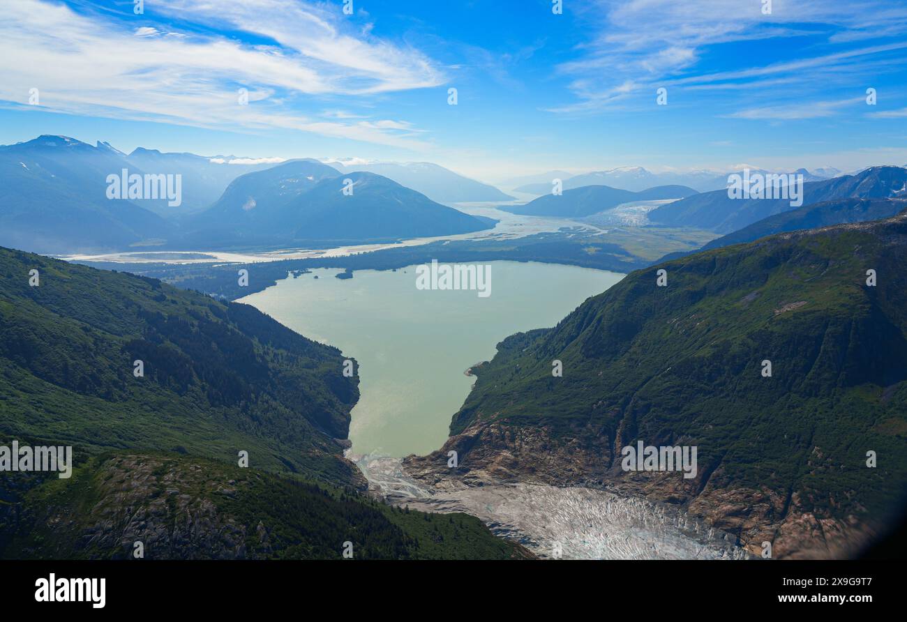 Aerial view of a turquoise lake filled with melt water from a glacier ...