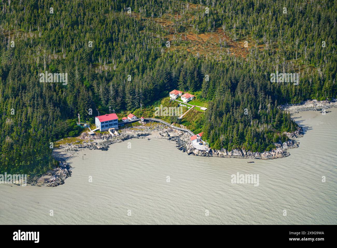 Aerial view of isolated houses built on the shores of the Taku River ...