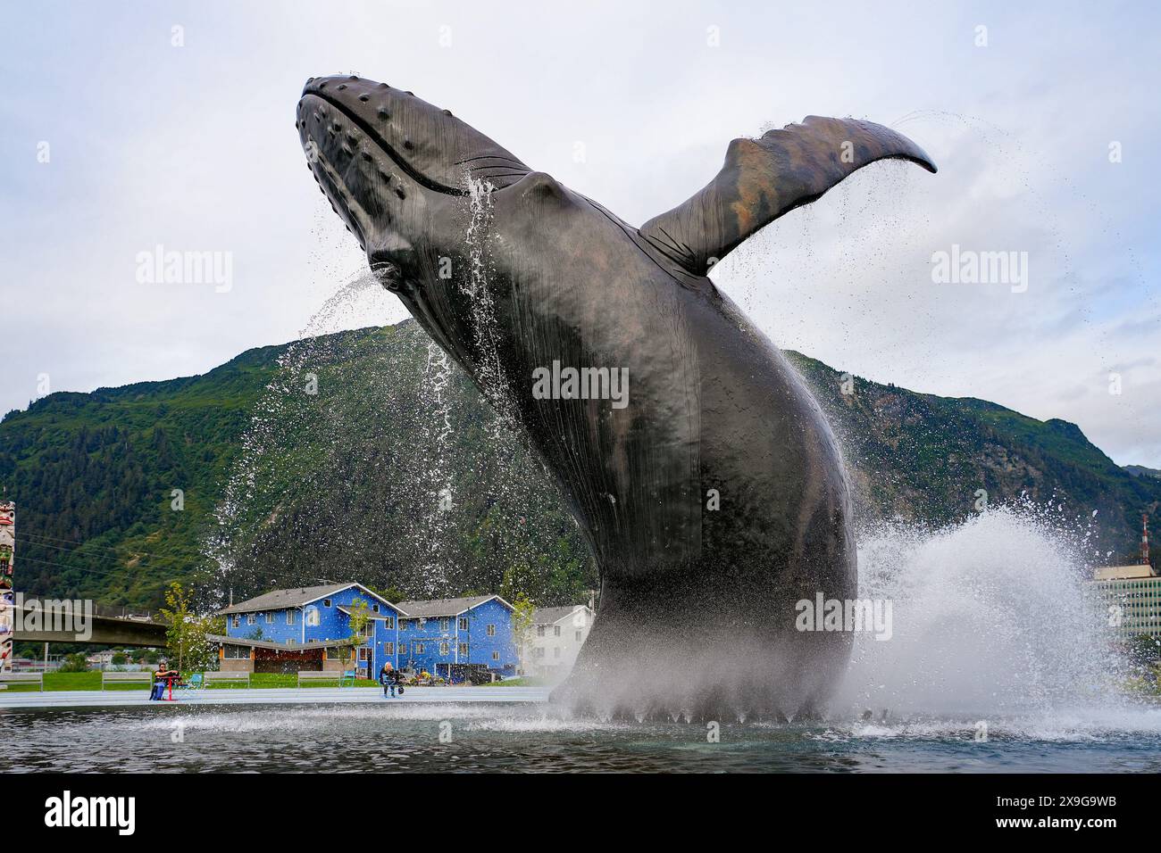 Tahku, a bronze sculpture of a breaching humpback whale in the middle ...