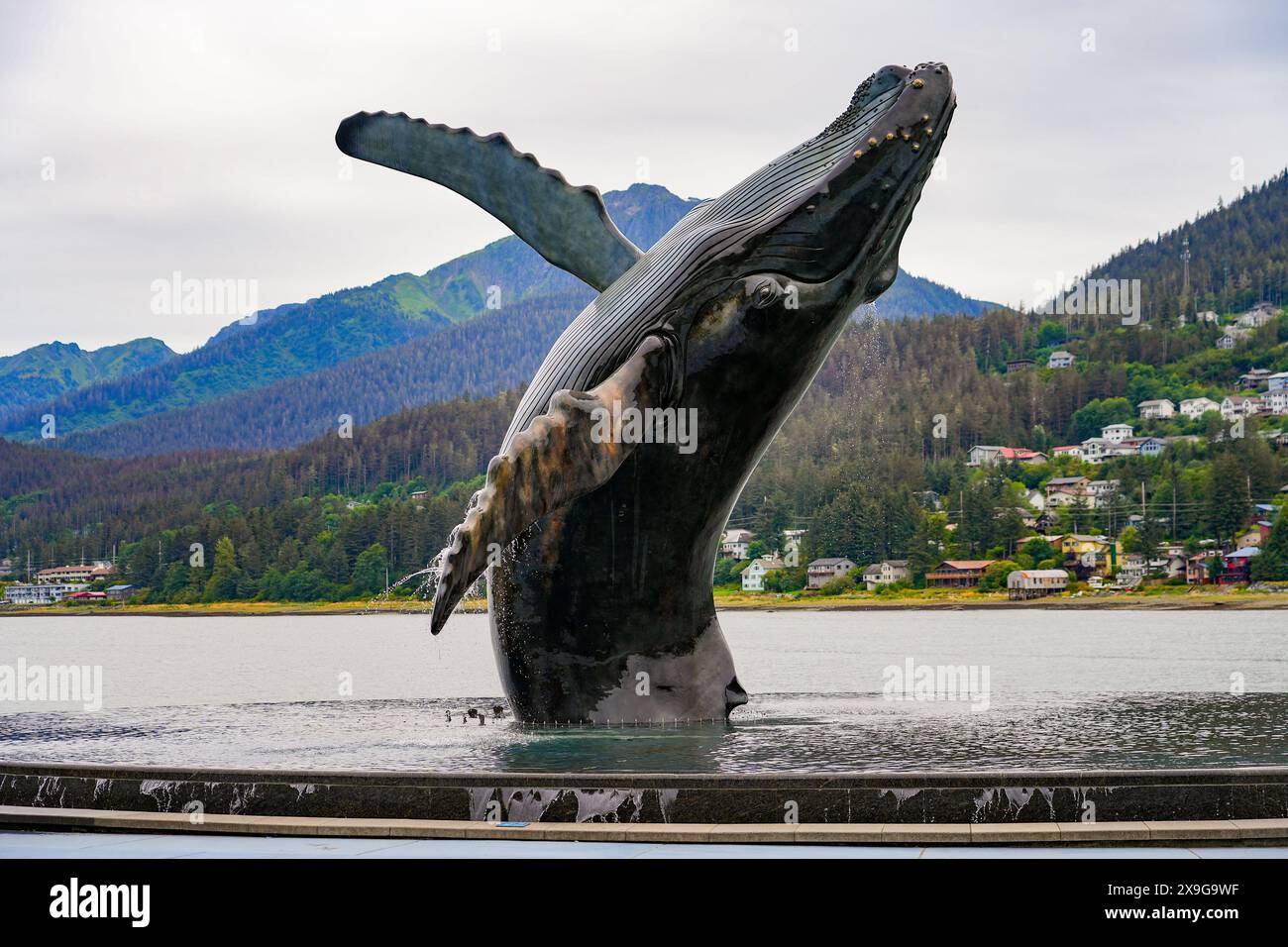 Tahku, a bronze sculpture of a breaching humpback whale in the middle ...