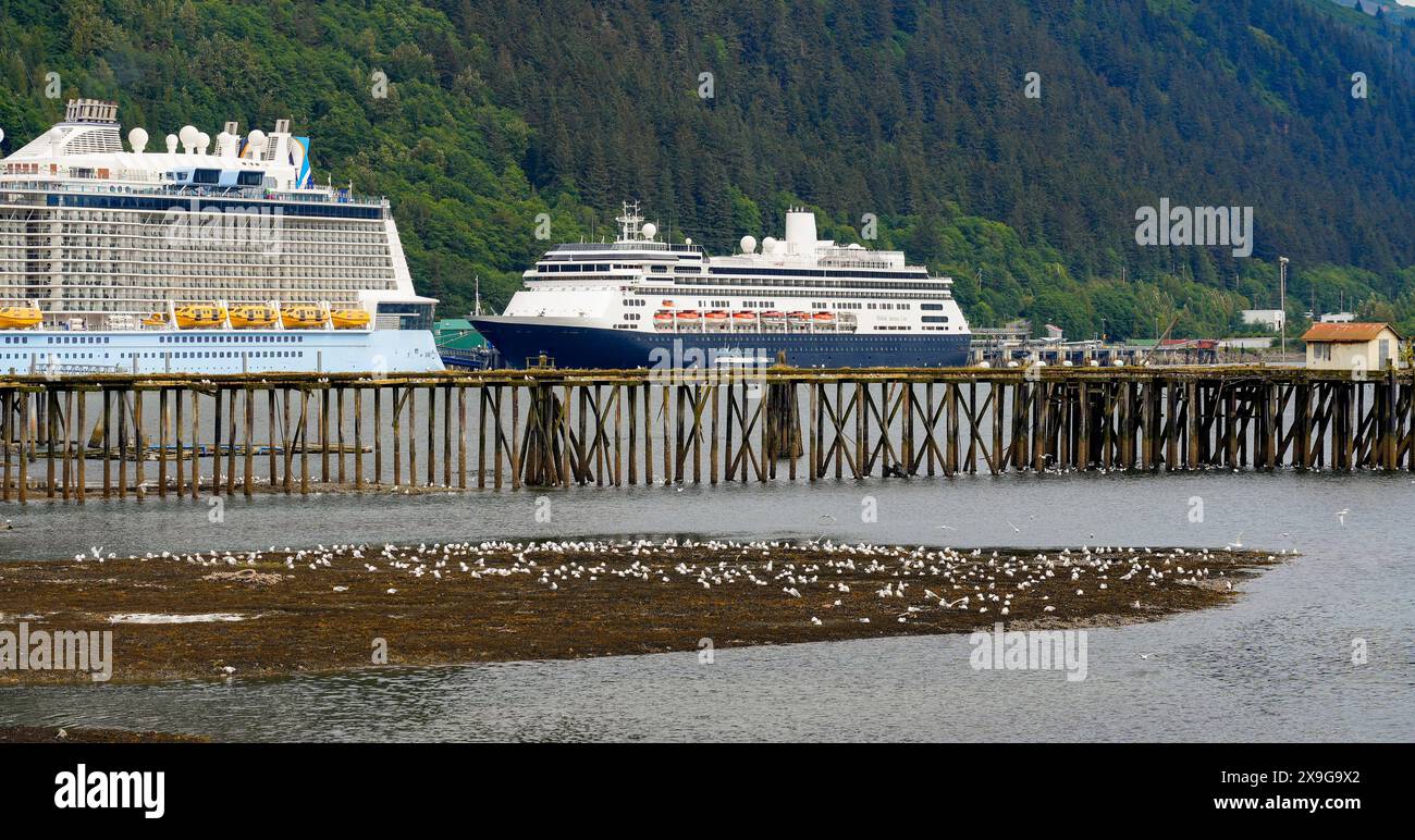 Wooden pier in front of a cruise ship moored in Juneau's harbour in the ...