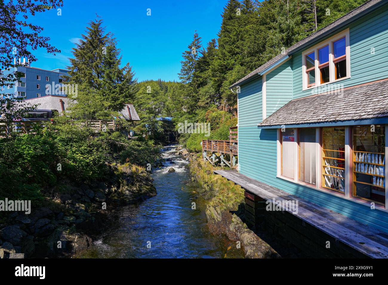 Rapids flowing by the historic wooden buildings of Creek Street in ...